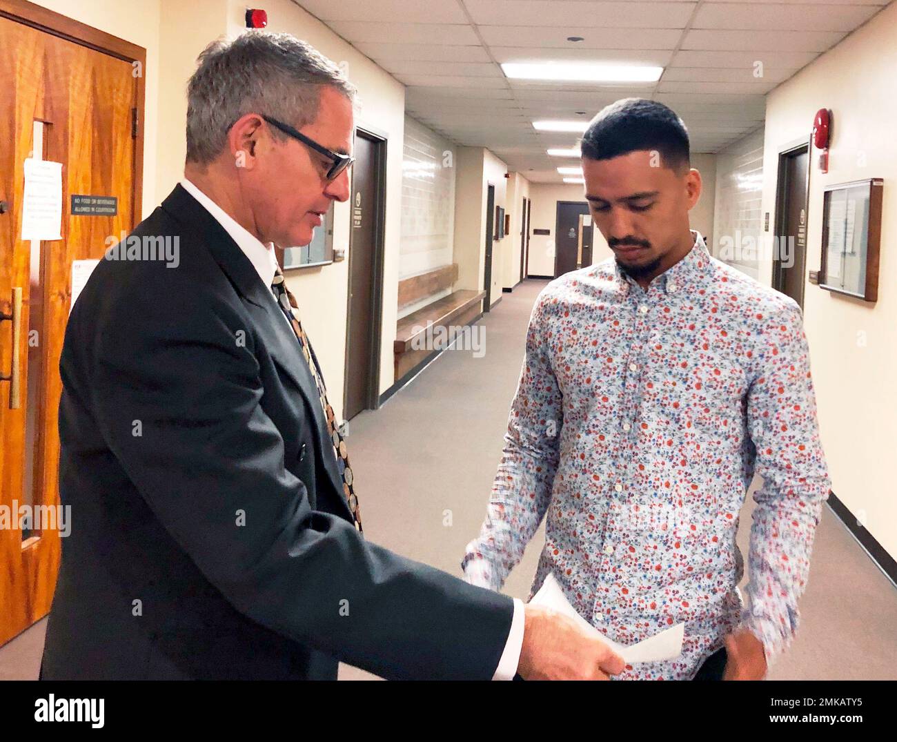 Mixed martial arts fighter Arnold Berdon, right, talks to his attorney ...