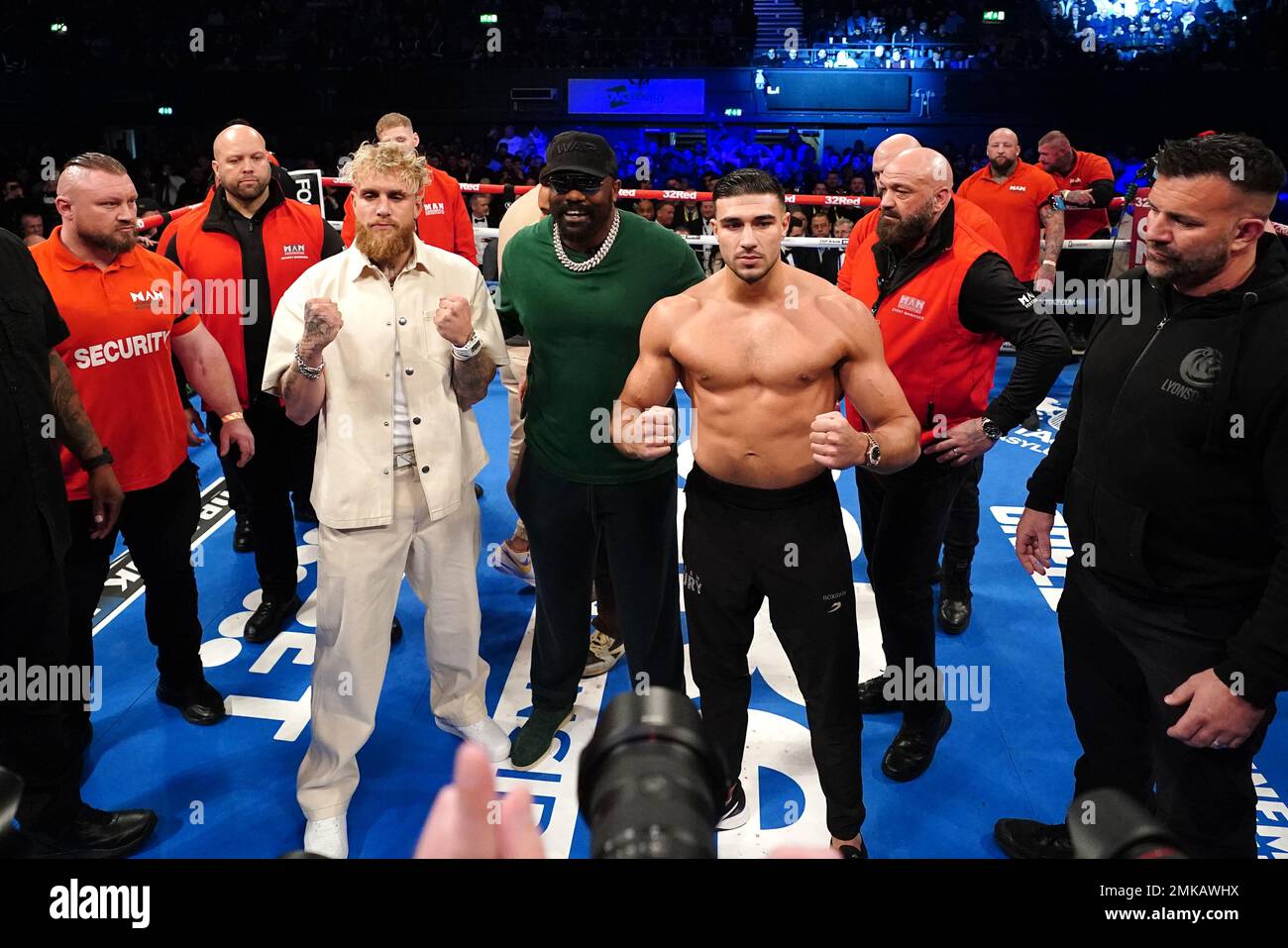 Jake Paul and Tommy Fury pose after a face-off in the ring, alongside ...