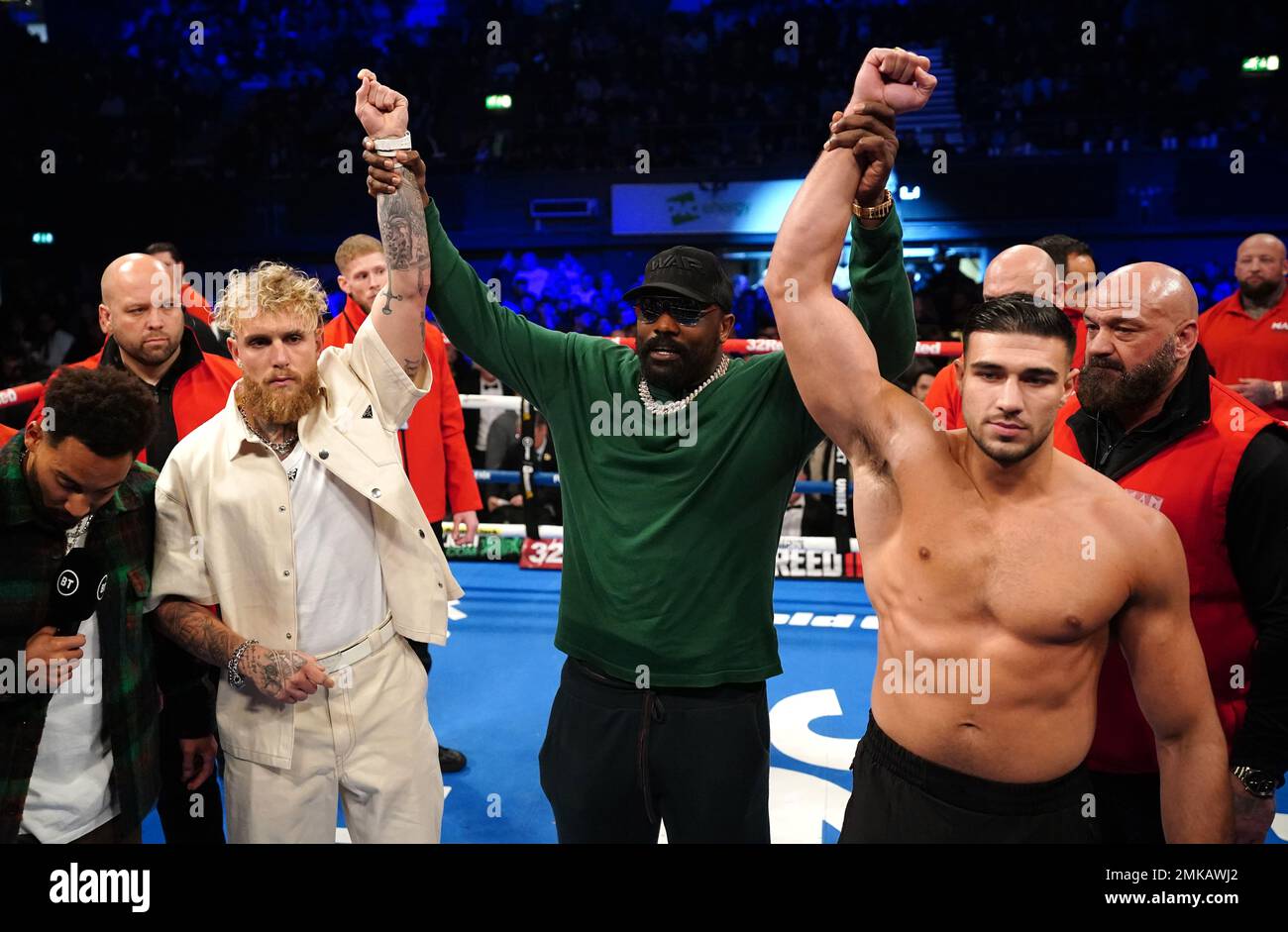 Jake Paul and Tommy Fury pose after a face-off in the ring, alongside ...