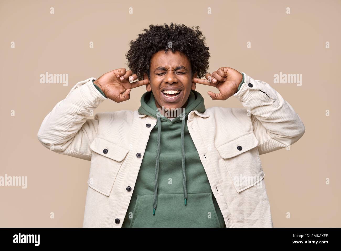 African American gen z guy closing ears isolated on beige background ...