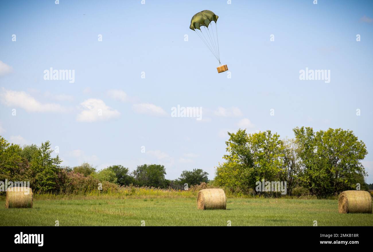 A box of Meals-Ready-to-Eat floats to the ground during an air drop and ...