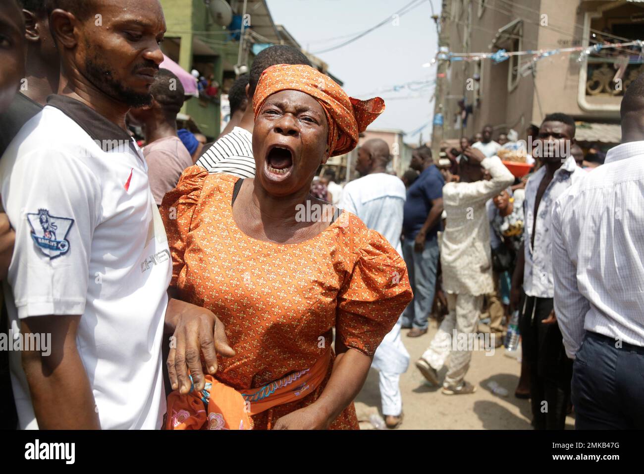 A woman cries as a body of child is recovered from the rubble of a ...
