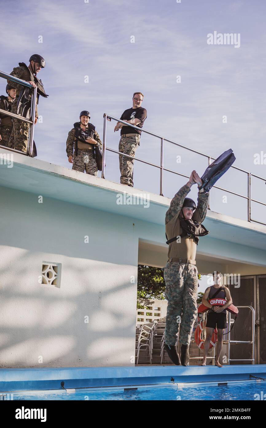 U.S. Marines with III Marine Expeditionary Force, jump into the water ...