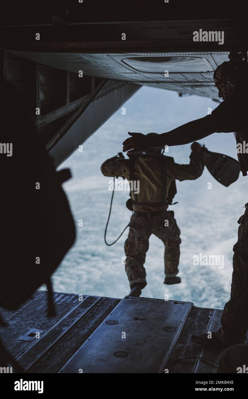 A U.S. Marine with III Marine Expeditionary Force (MEF), jumps from a ...