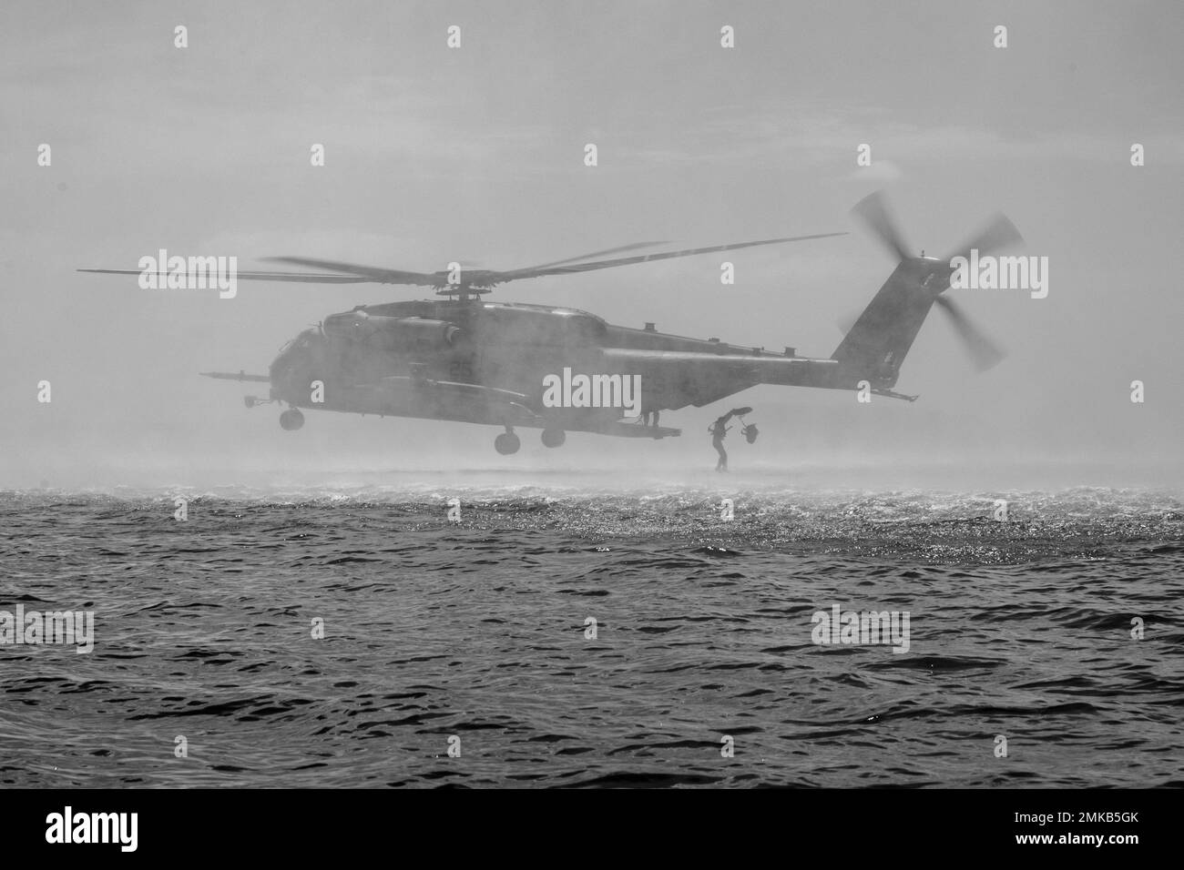 A U.S. Marine with III Marine Expeditionary Force (MEF), jumps from a ...