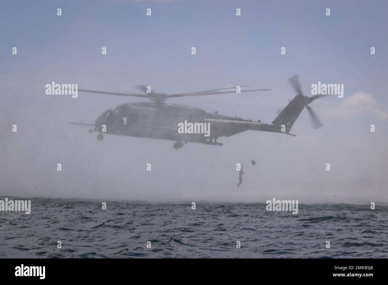 A U.S. Marine with III Marine Expeditionary Force (MEF), jumps from a ...