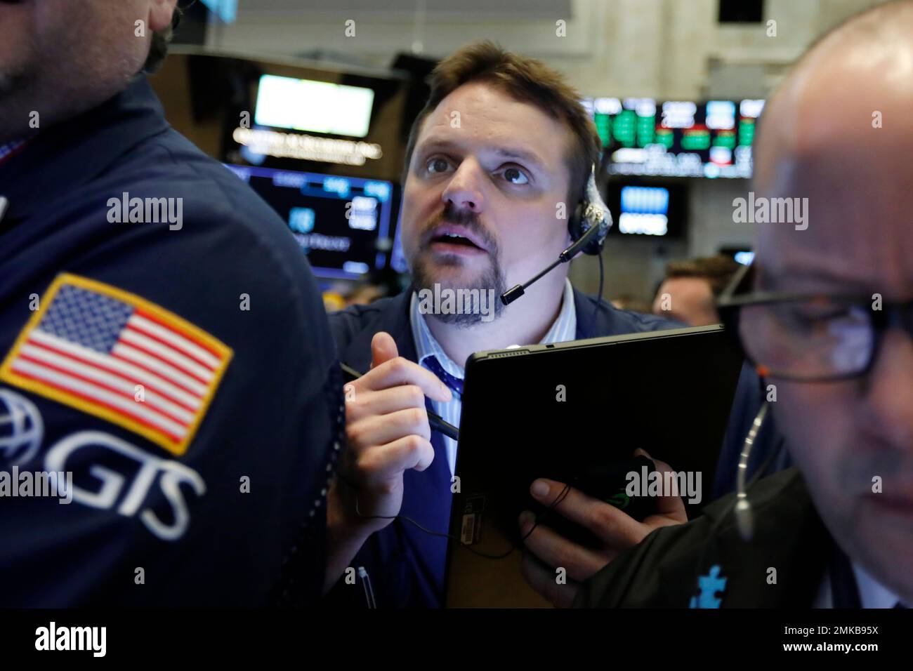 Trader Michael Milano works on the floor of the New York Stock Exchange ...