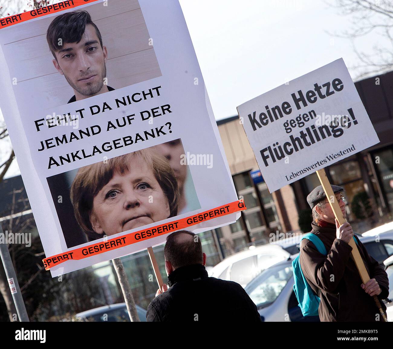 A man protests with a poster showing the defendant and German ...