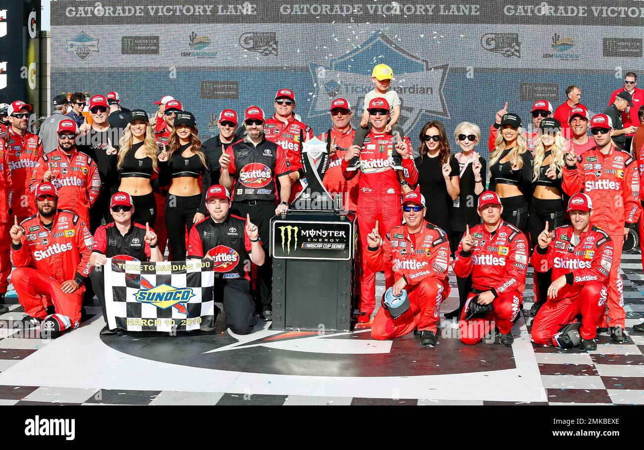 Kyle Busch, with his son Brexton, center, and his race team celebrate ...
