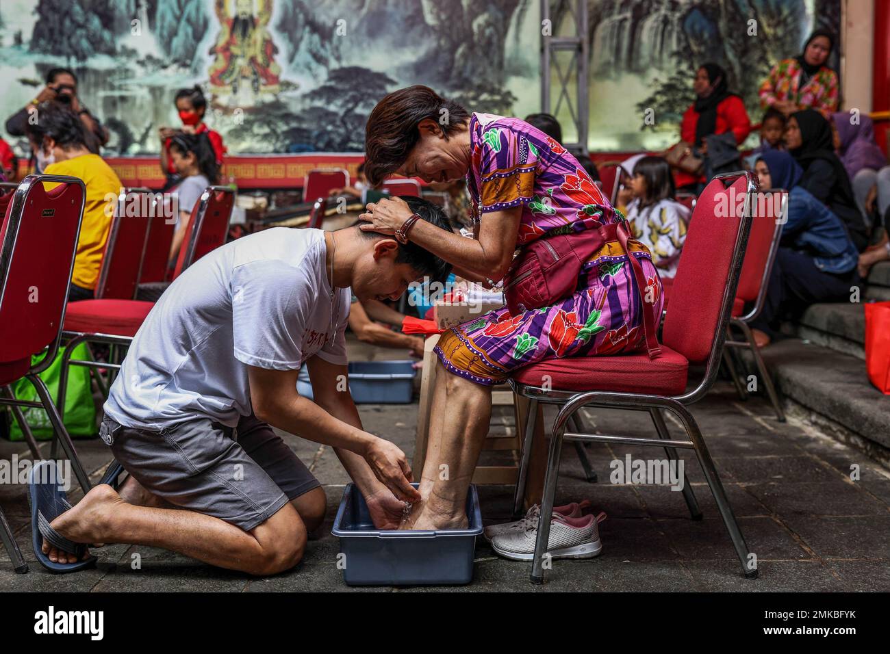 A child washes his mother's feet ahead of the Cap Go Meh festival ...
