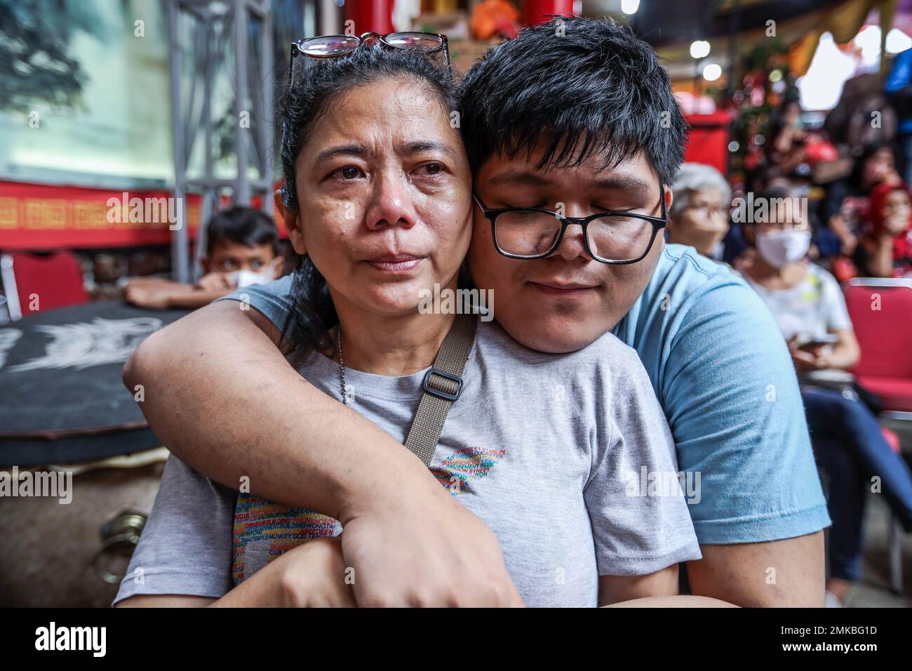 A child hugs his mother ahead of the Cap Go Meh festival, marking the ...