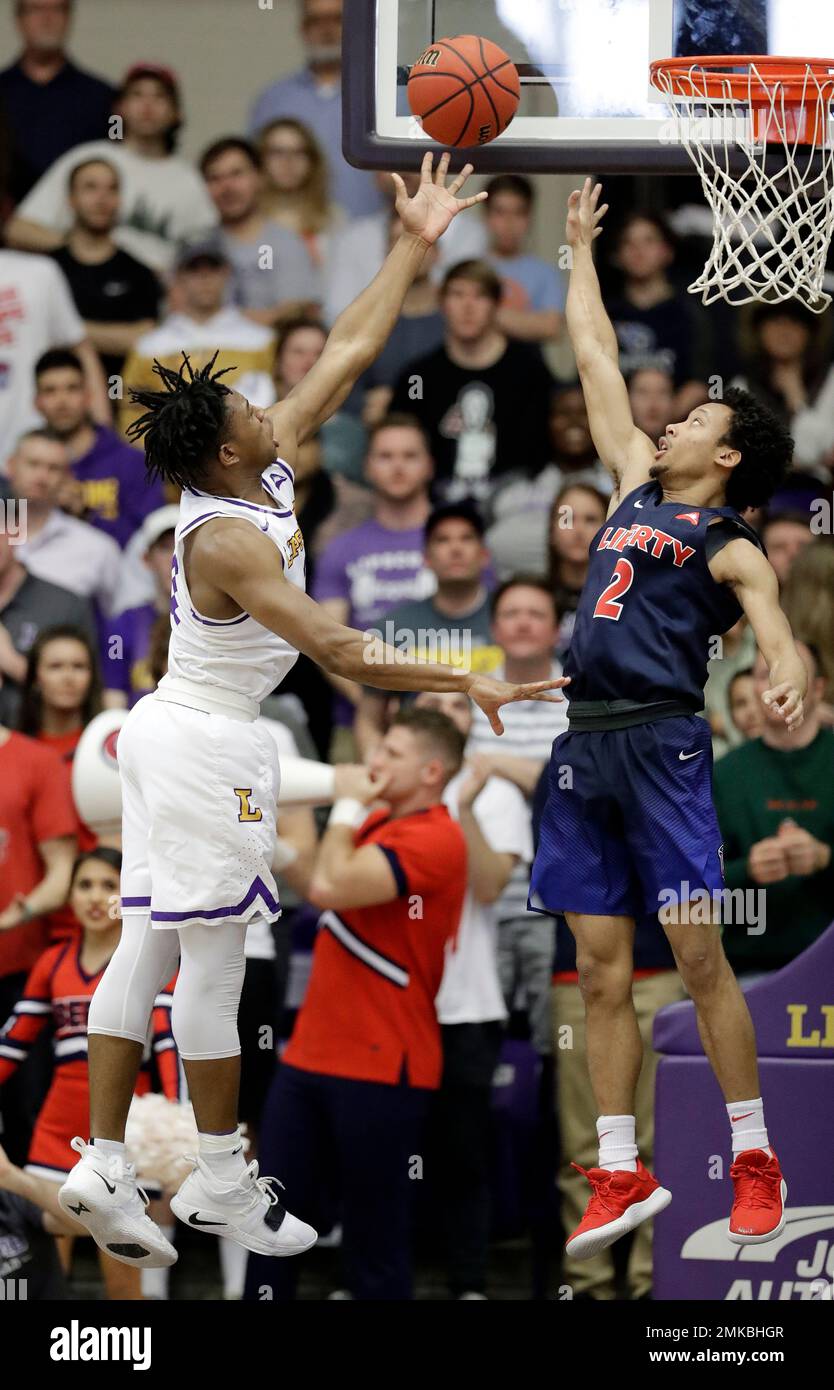 Lipscomb guard Kenny Cooper, left, shoots against Liberty guard Darius ...