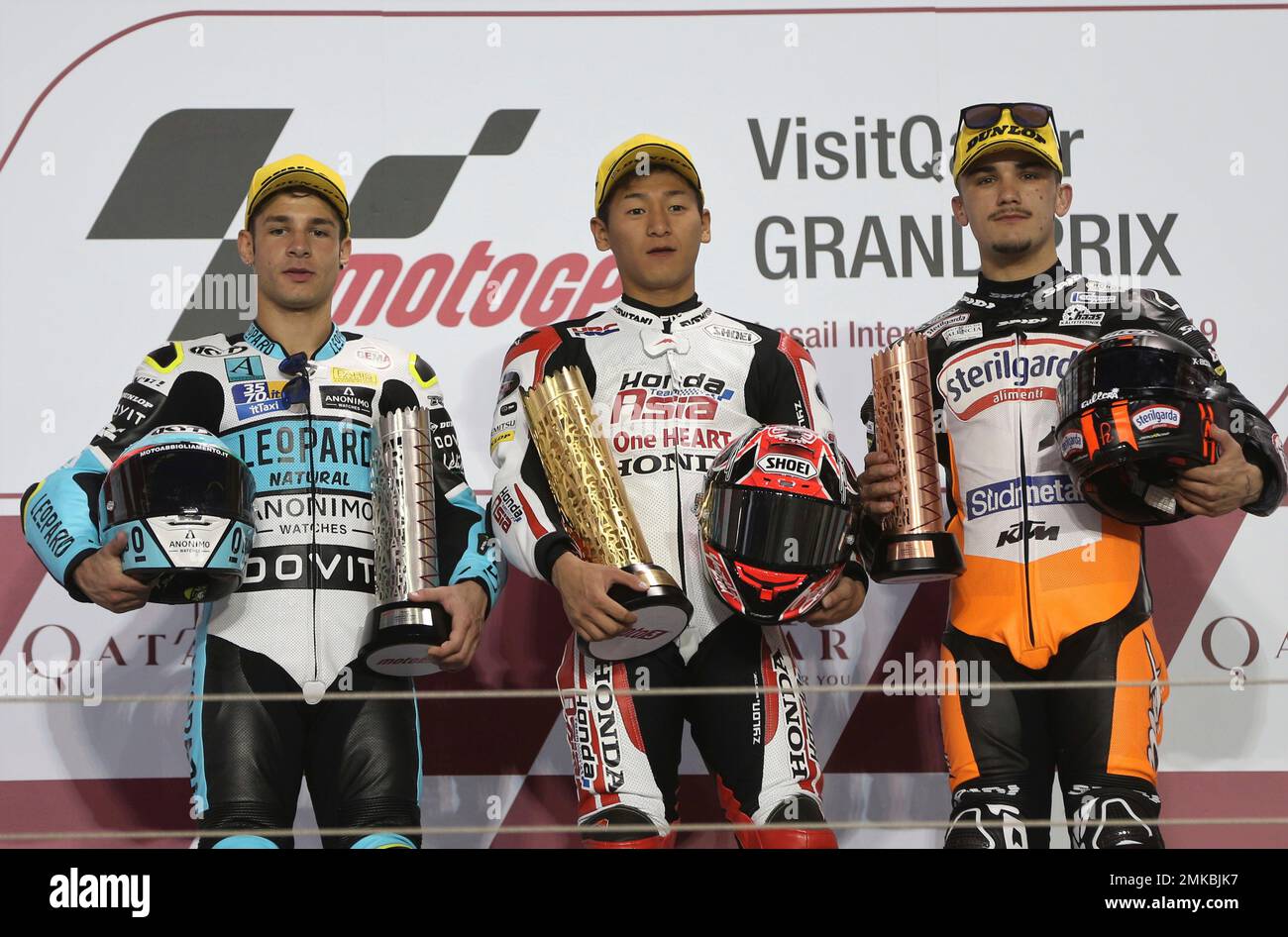 Japanese rider Kaito Toba, center, celebrates after winning the Moto3 ...