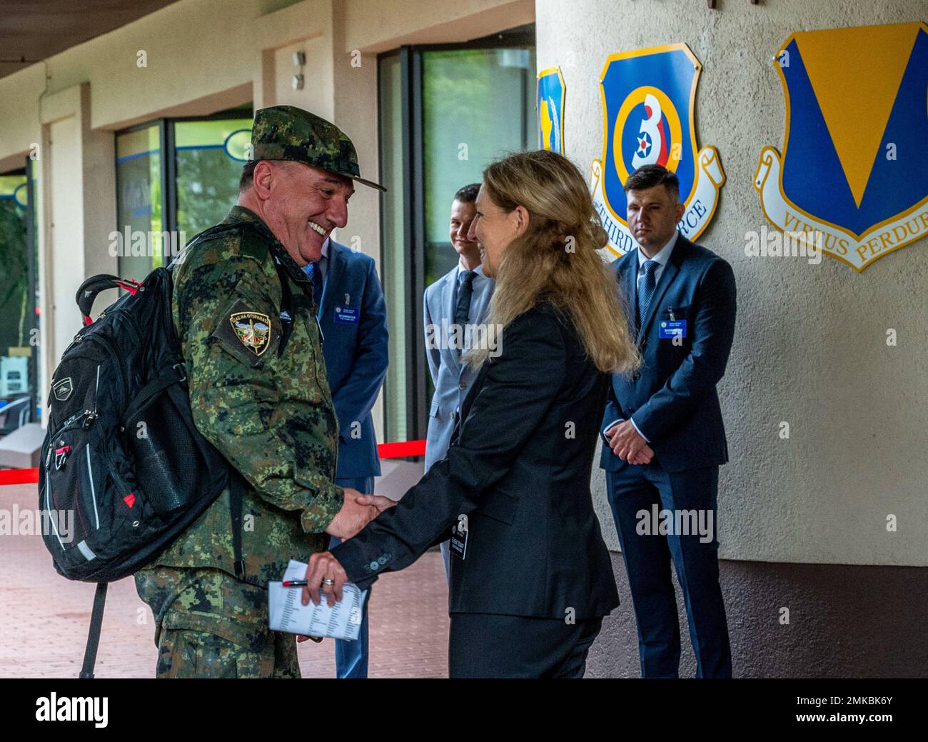Sarah Farnsworth, Office of the Secretary of Defense Protocol, greets a ...