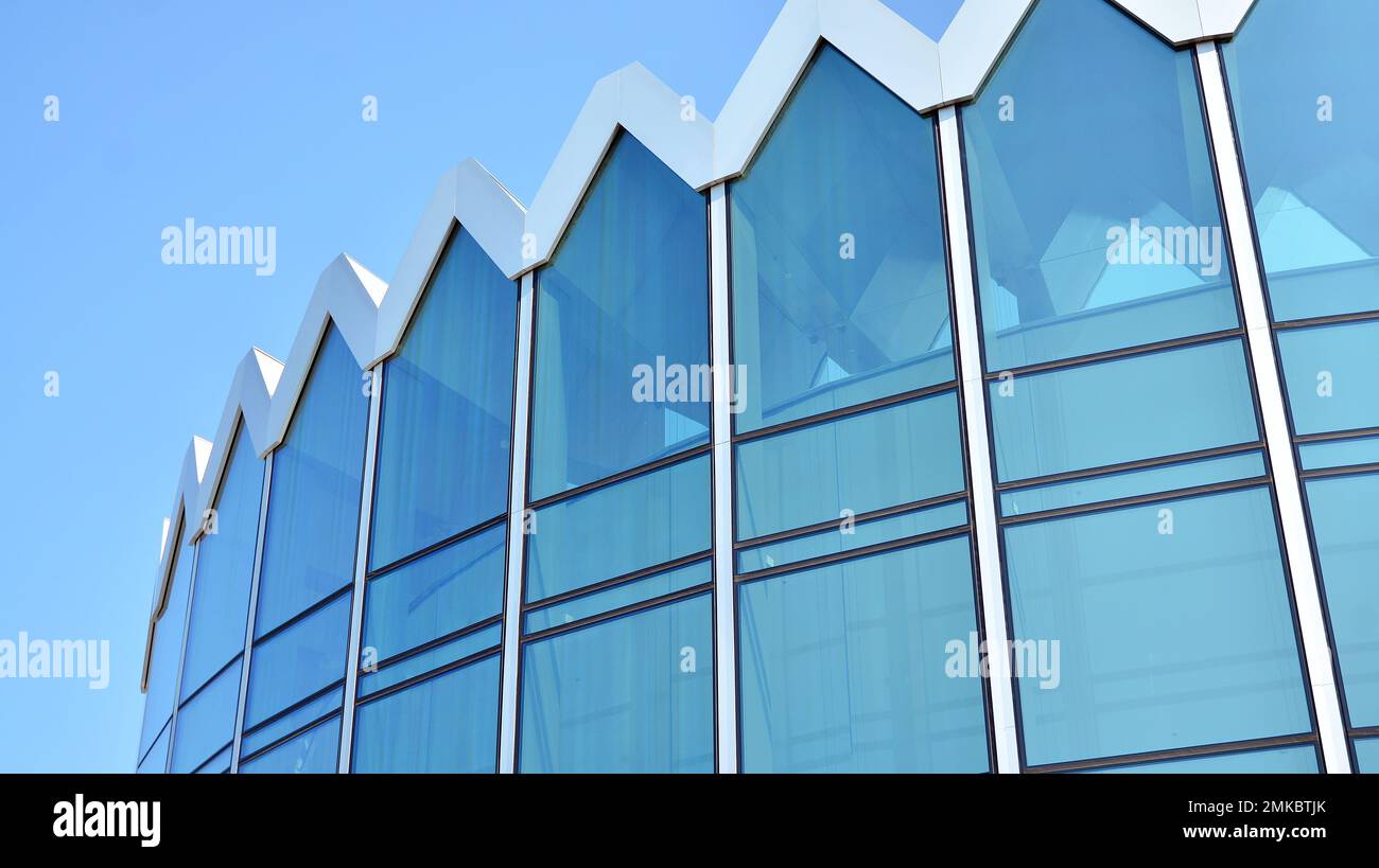 Abstract closeup of the glass-clad facade of a modern building covered ...