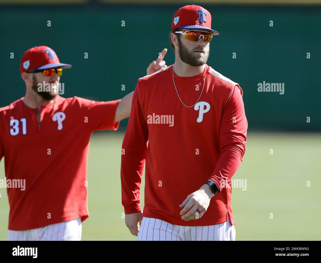 Philadelphia Phillies' Bryce Harper, right, walks with left fielder ...