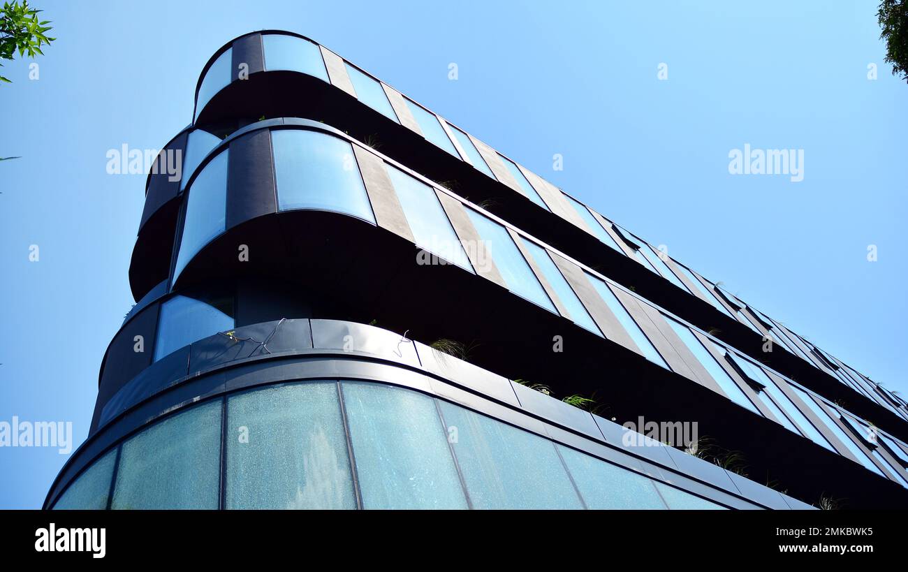 Abstract closeup of the glass-clad facade of a modern building covered ...