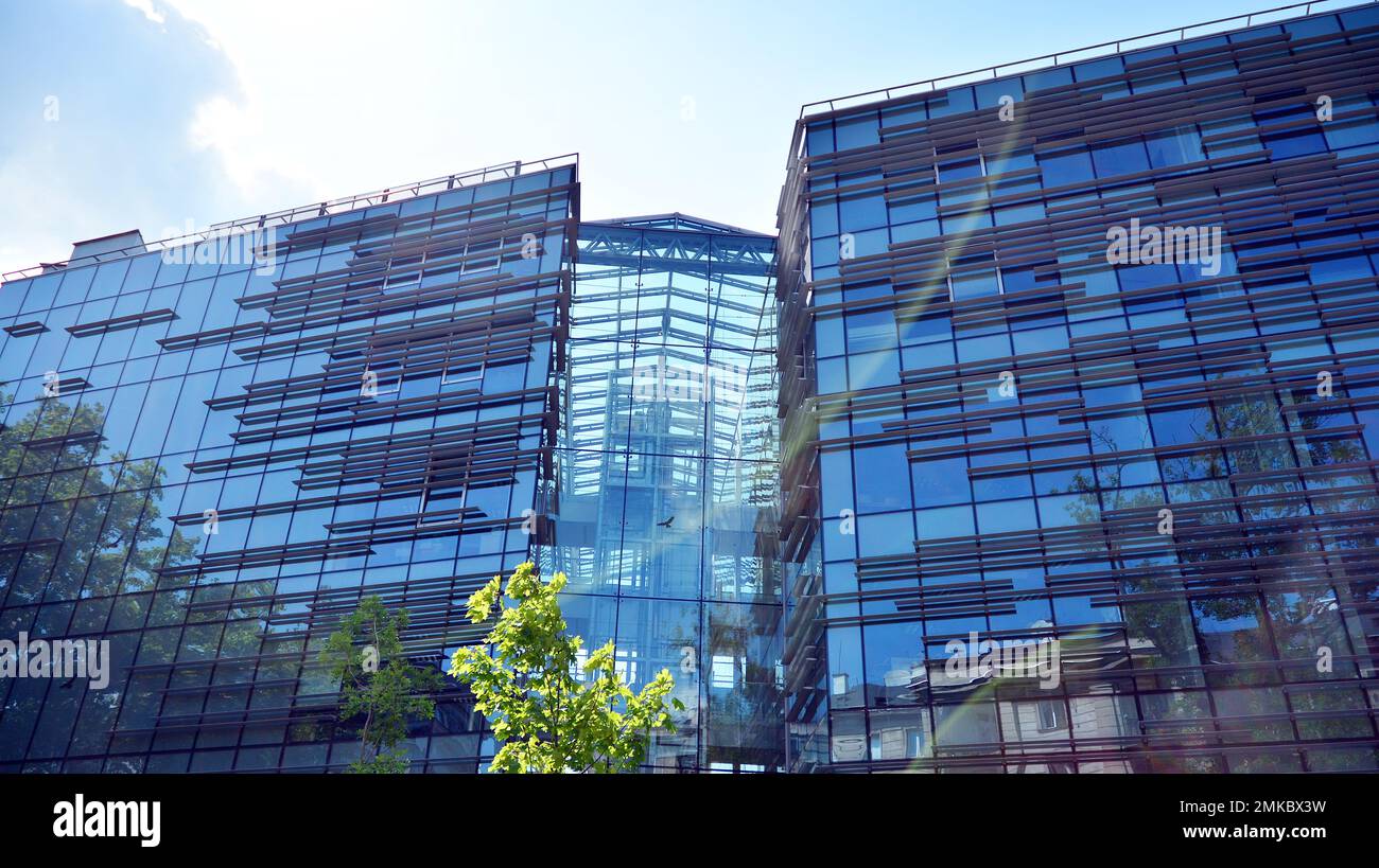 Abstract closeup of the glass-clad facade of a modern building covered ...