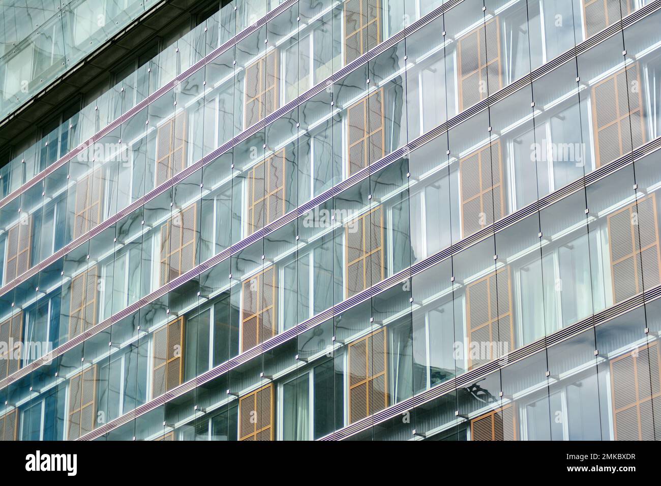 Abstract closeup of the glass-clad facade of a modern building covered ...
