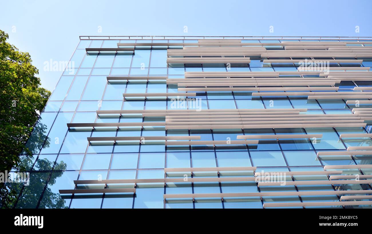 Abstract closeup of the glass-clad facade of a modern building covered ...