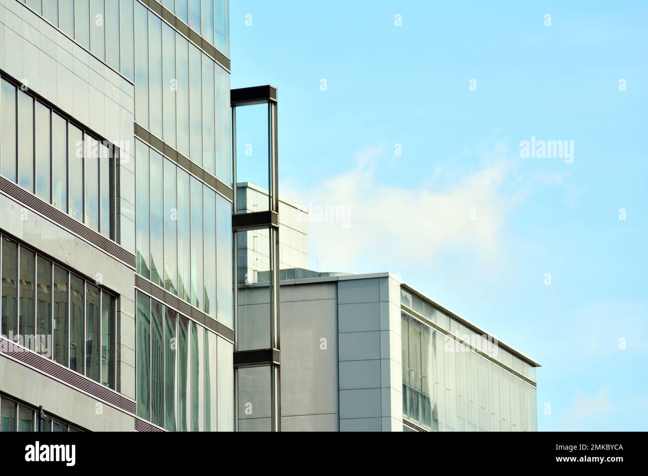 Abstract closeup of the glass-clad facade of a modern building covered ...