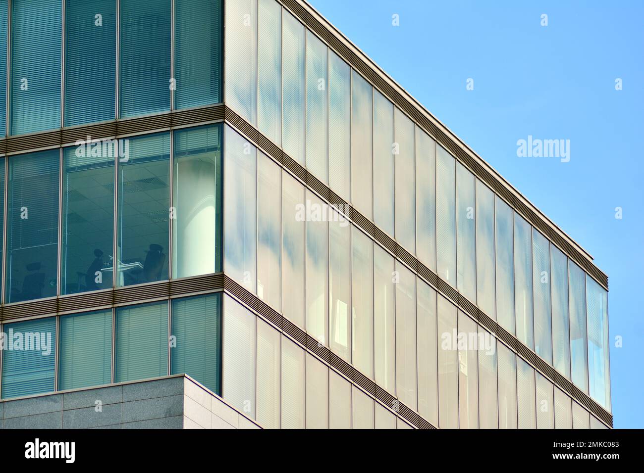 Abstract closeup of the glass-clad facade of a modern building covered ...