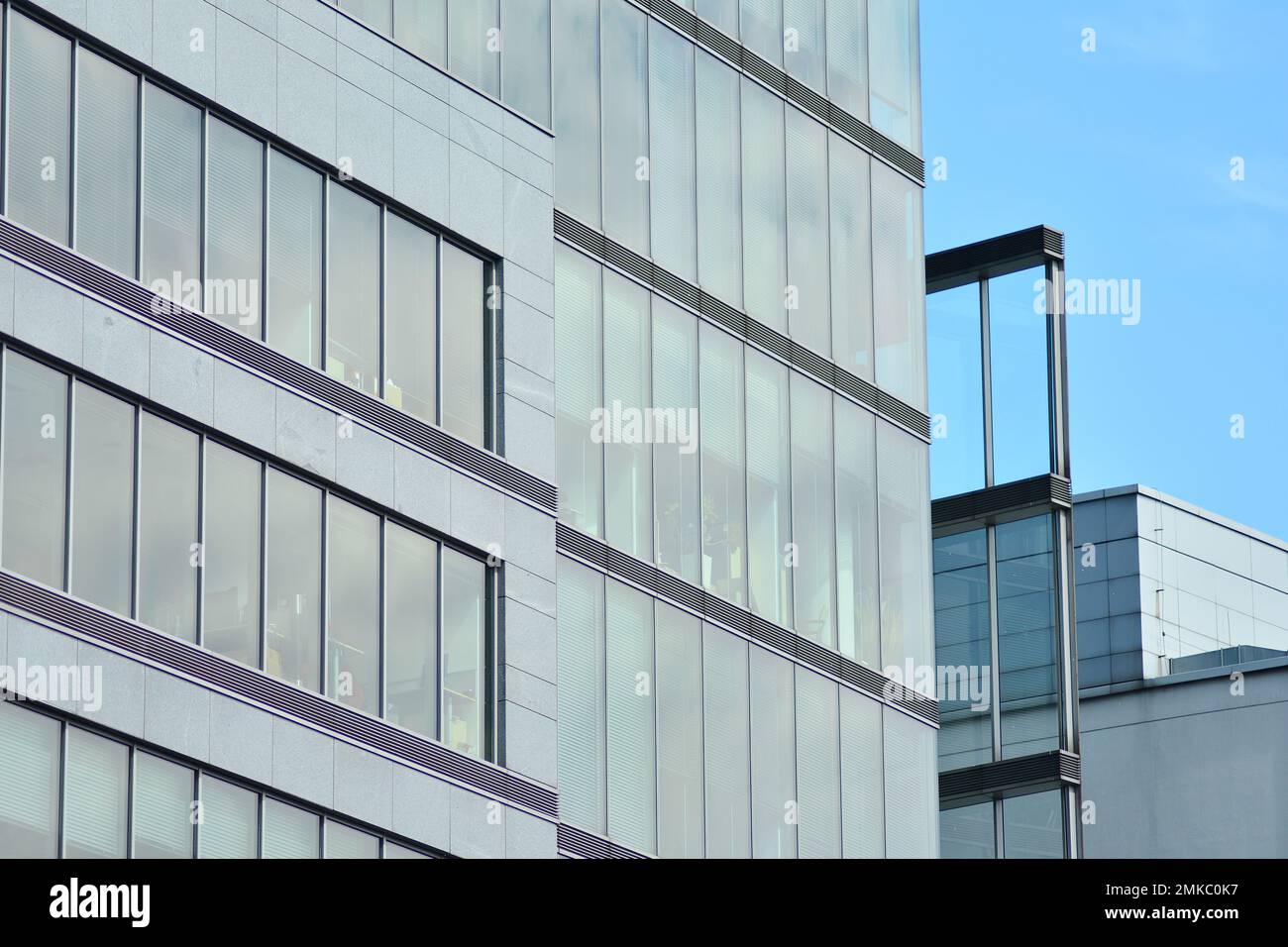 Abstract closeup of the glass-clad facade of a modern building covered ...