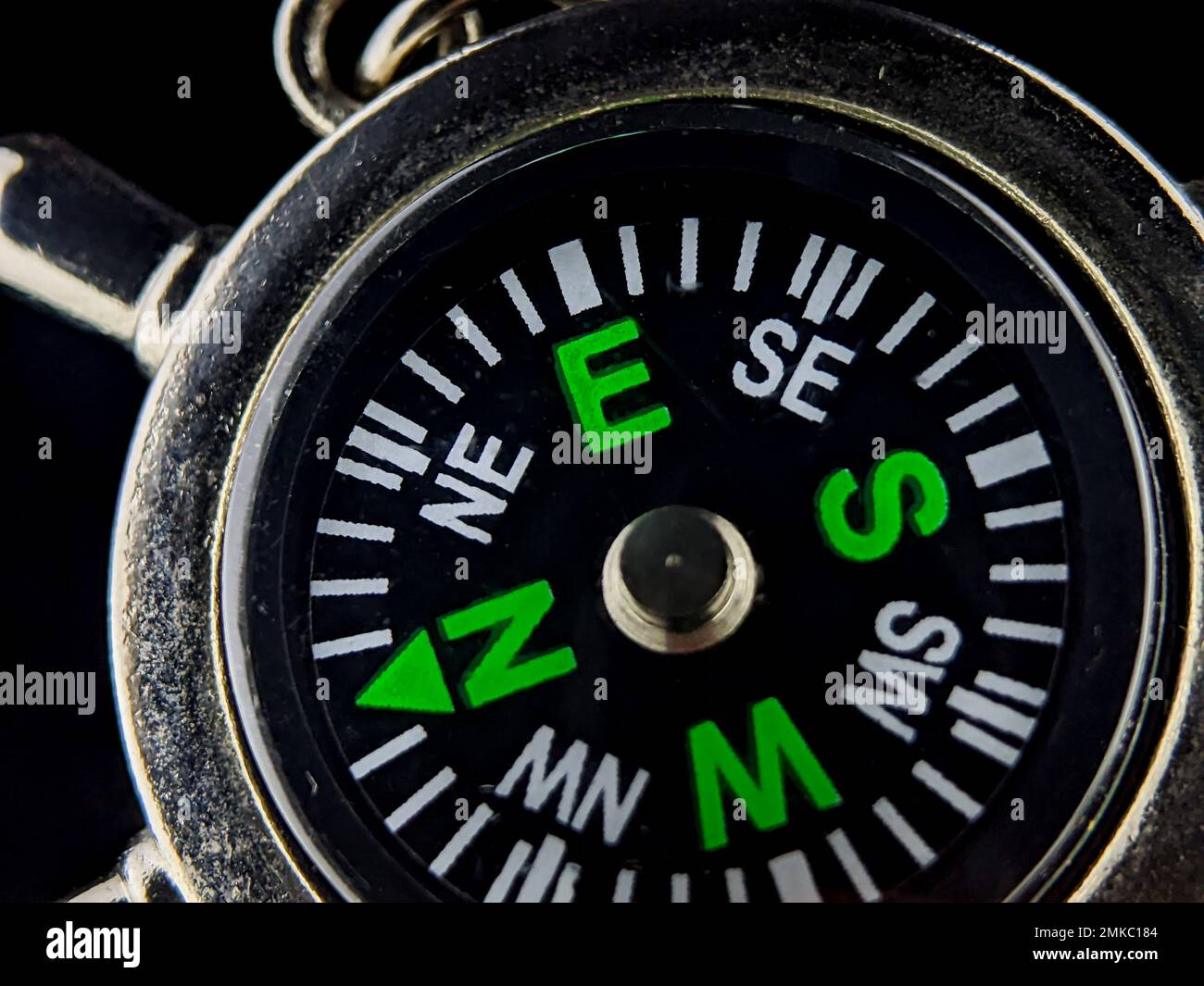 Close-up stainless steel compass keychain on black background Stock ...