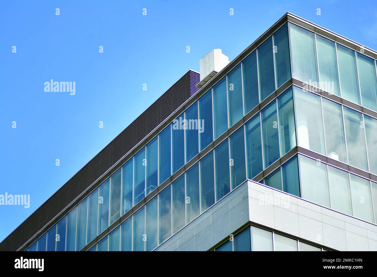 Abstract closeup of the glass-clad facade of a modern building covered ...