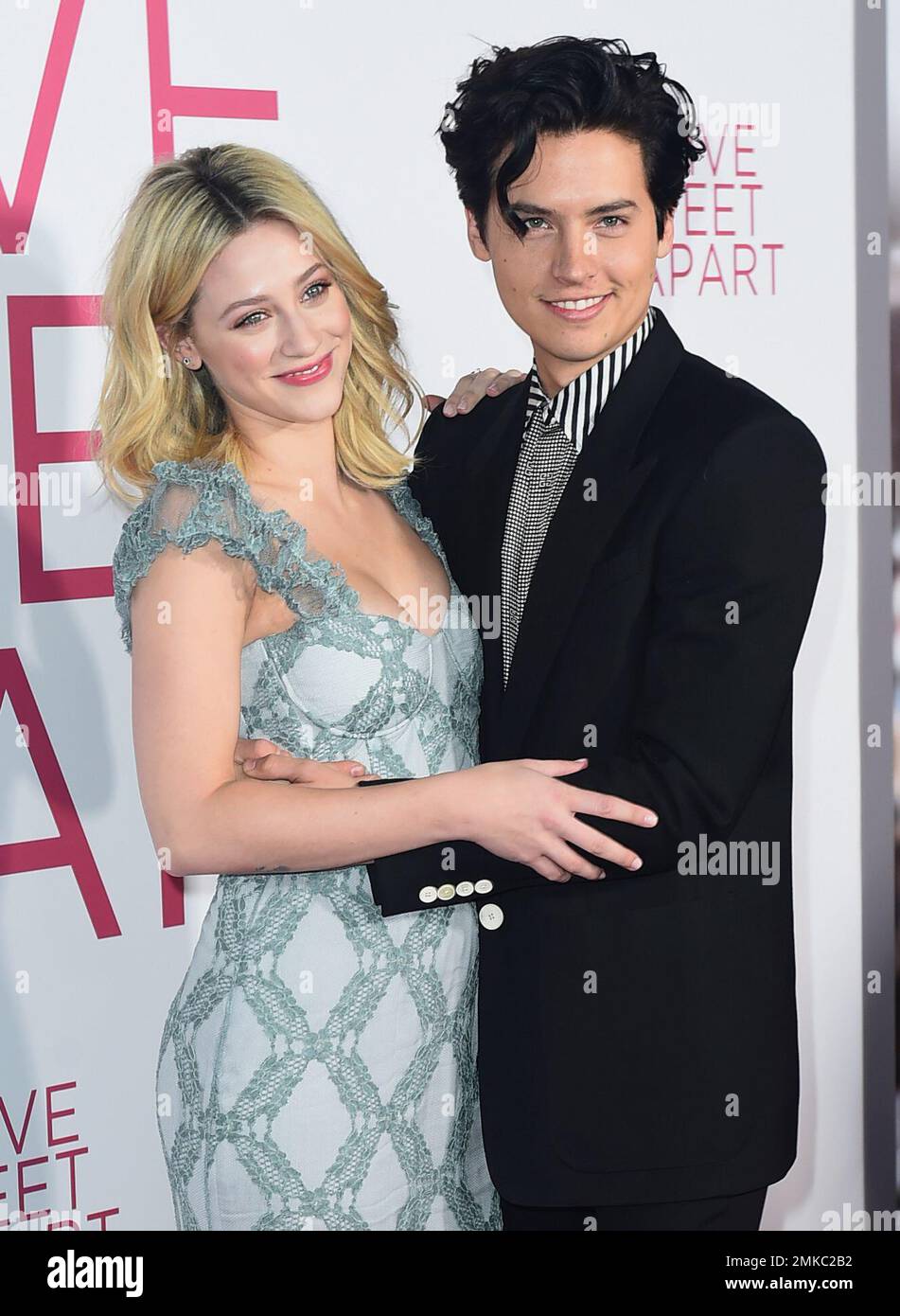 Lili Reinhart, left, and Cole Sprouse arrive at the Los Angeles ...