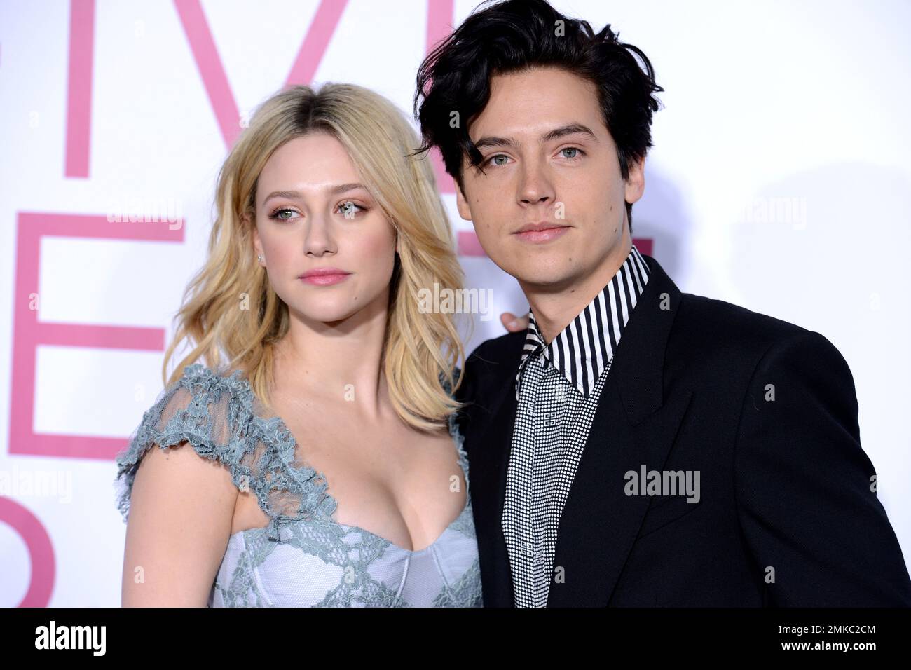 Lili Reinhart, left, and Cole Sprouse arrive at the Los Angeles ...