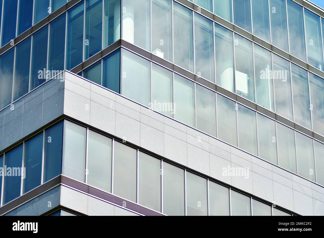 Abstract closeup of the glass-clad facade of a modern building covered ...