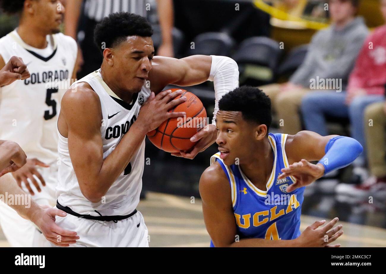 Colorado guard Tyler Bey, left, pulls in a rebound as UCLA guard Jaylen ...