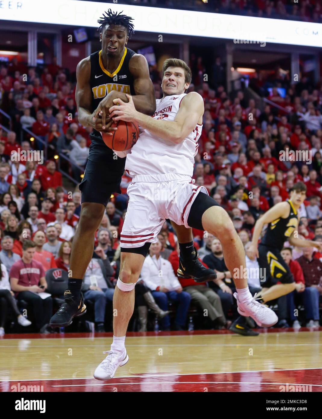 Iowa's Tyler Cook, left, and Wisconsin's Ethan Happ battle for a ...