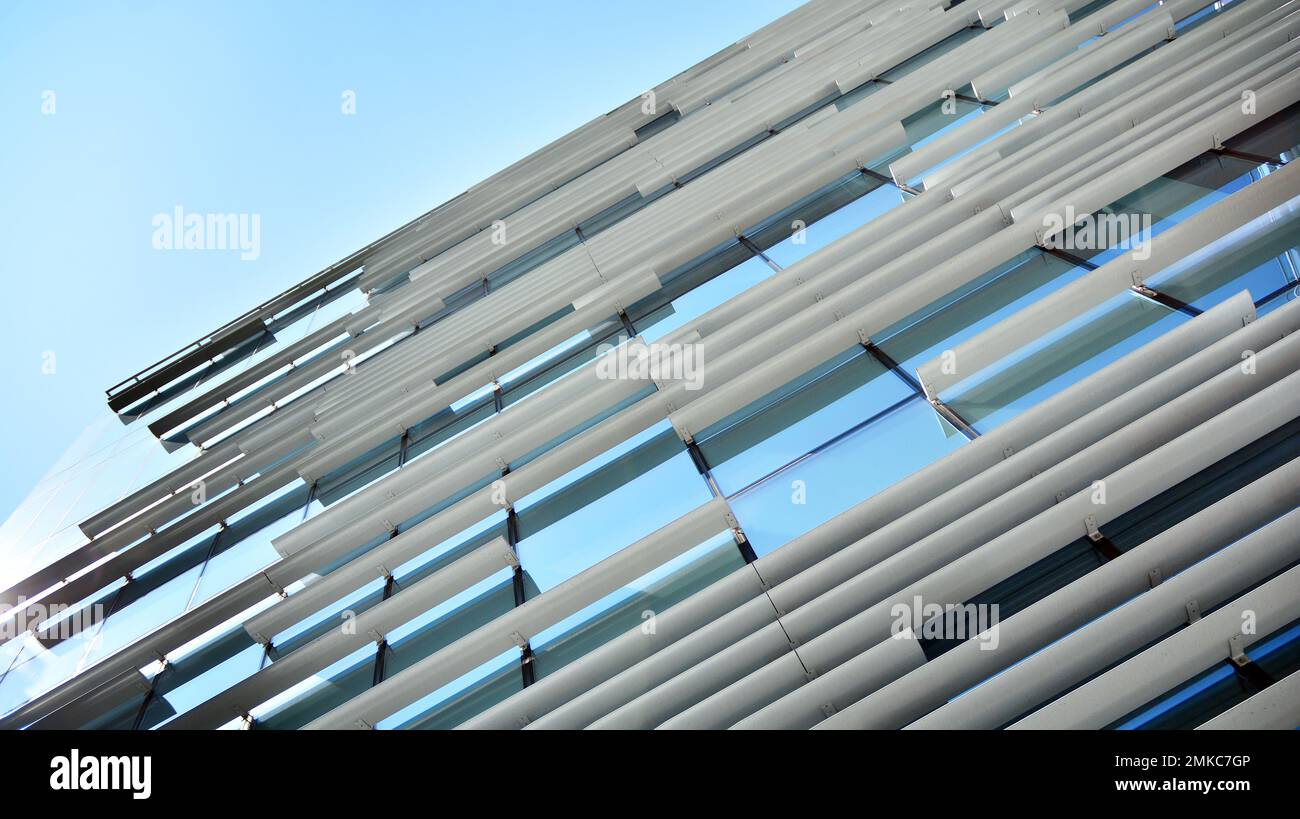 Abstract closeup of the glass-clad facade of a modern building covered ...