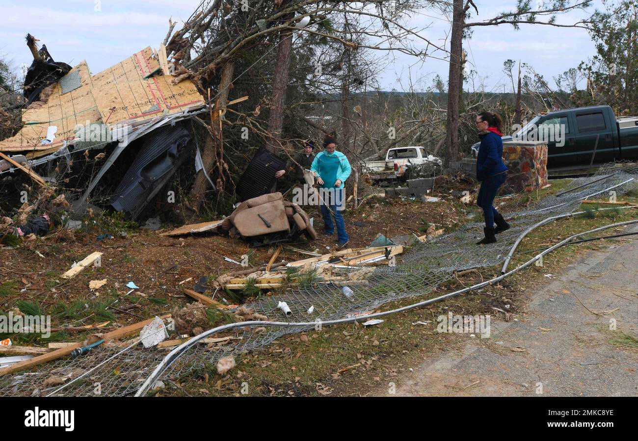 Residents and family members sift through the debris of their homes ...