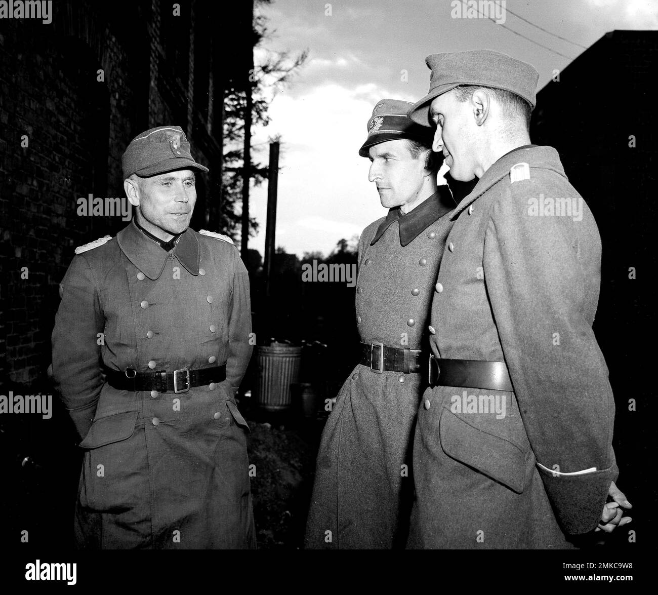 Col. Gerhard Wilck, the Germany commander, left, talks to his officers ...