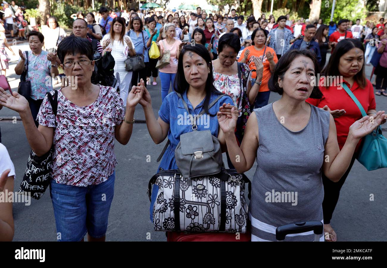 Roman Catholic devotees with a cross symbol on their forehead attends a ...