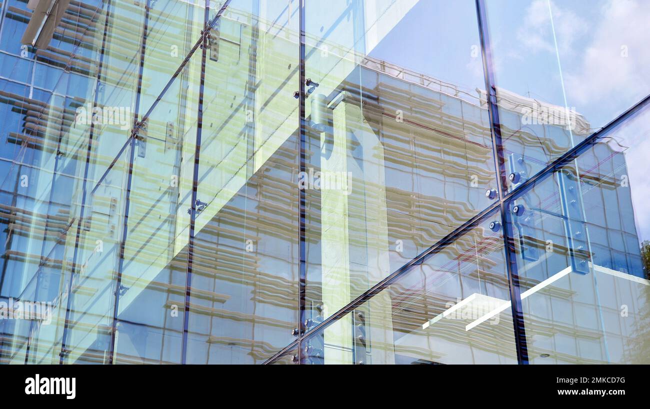 Abstract closeup of the glass-clad facade of a modern building covered ...