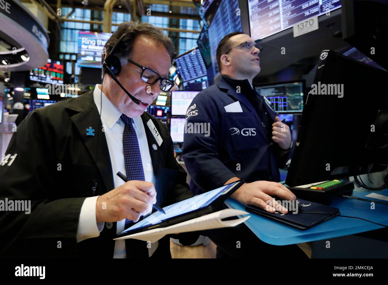 Trader Sal Suarino, left, and specialist Anthony Matesic work on the ...