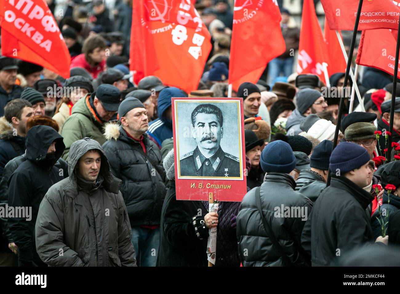 Communist party supporters carry red flags and portraits of Josef ...