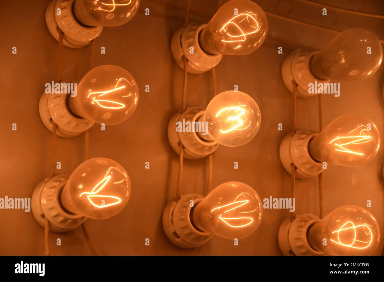 Glowing filaments inside a bunch of lightbulbs on a panel Stock Photo ...