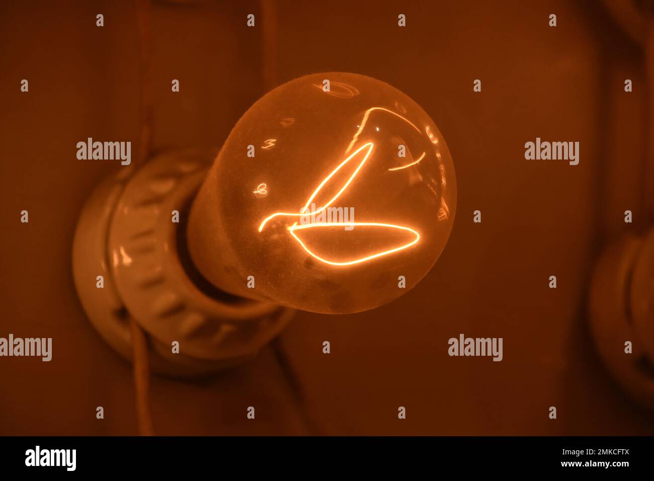 Bright lightbulb with a glowing filament lit up inside it Stock Photo ...