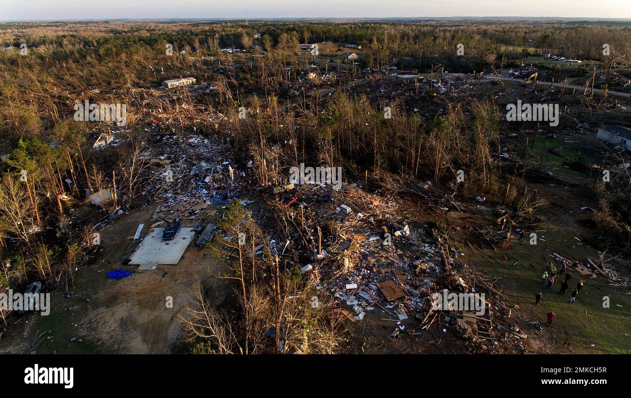 Debris is scattered over a neighborhood where homes were destroyed by a ...