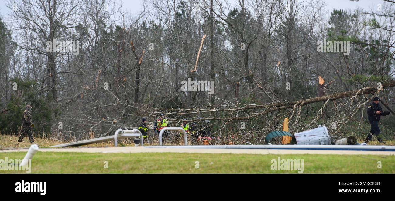 Emergency personnel comb the woods near tornado damage on Lee County ...