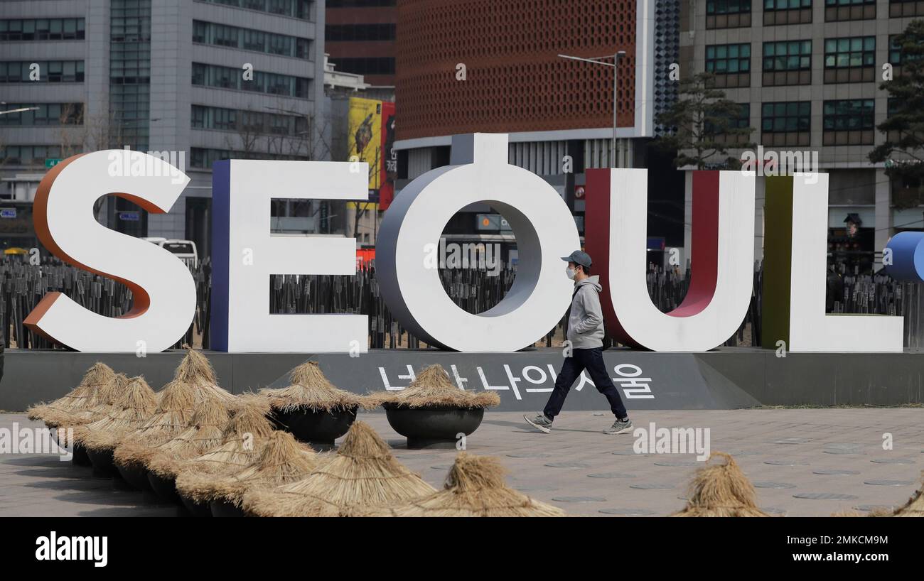 A man wearing a mask walks in downtown Seoul, South Korea, Monday ...