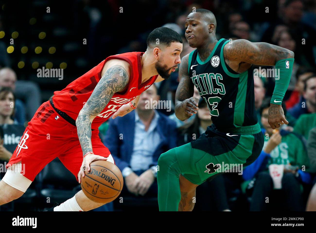 Houston Rockets' Austin Rivers (25) drives past Boston Celtics' Marcus ...