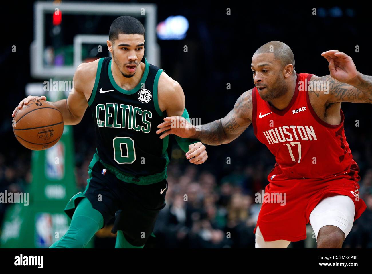 Boston Celtics' Jayson Tatum (0) drives past Houston Rockets' PJ Tucker ...