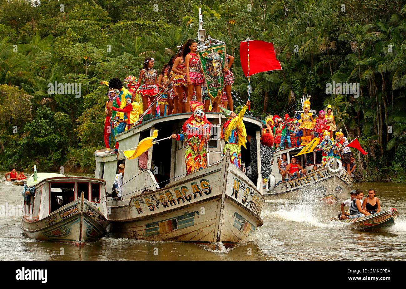 Carnival revelers ride on boats during the "Cordao da Bicharada ...