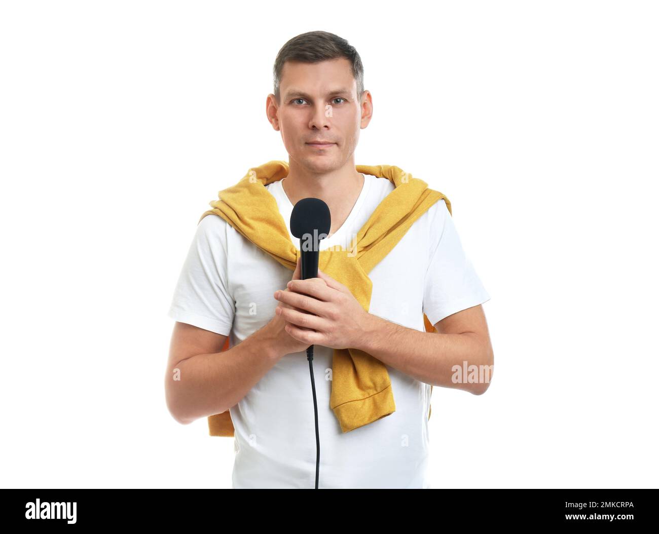 Male journalist with microphone on white background Stock Photo - Alamy